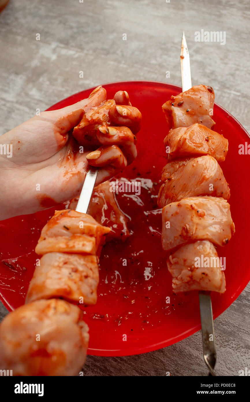 female hands skewer marinaded meat peaces on spit Stock Photo - Alamy