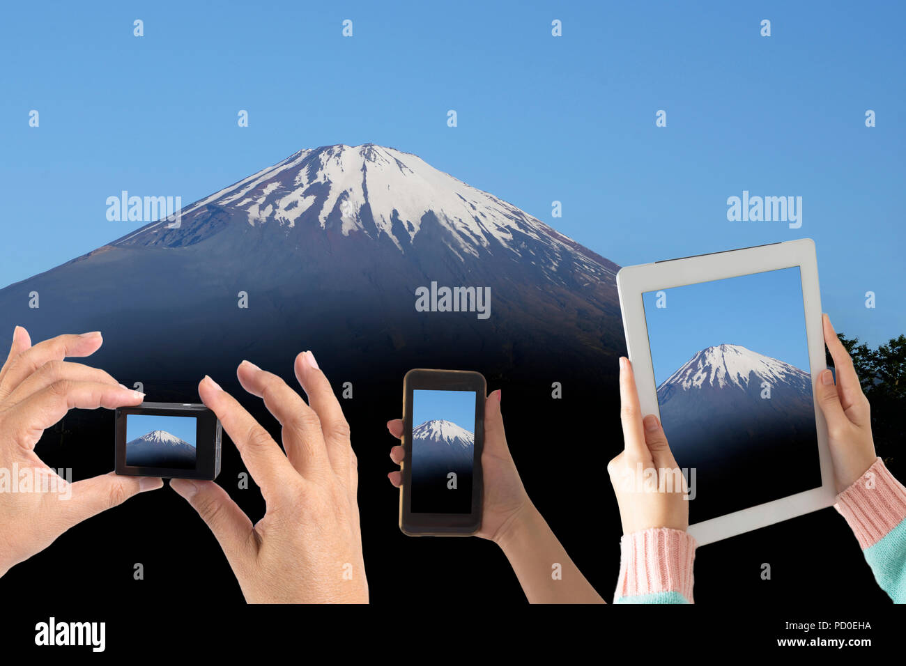 Many people lift hands up to take photo of Mount Fuji by smart device ...