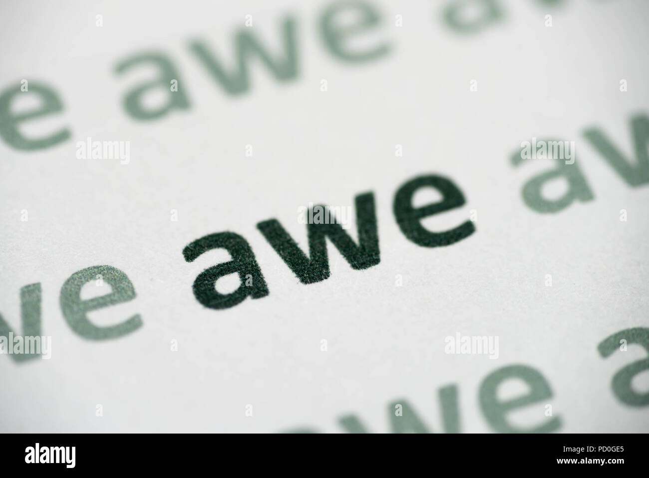 word awe printed on white paper macro Stock Photo - Alamy