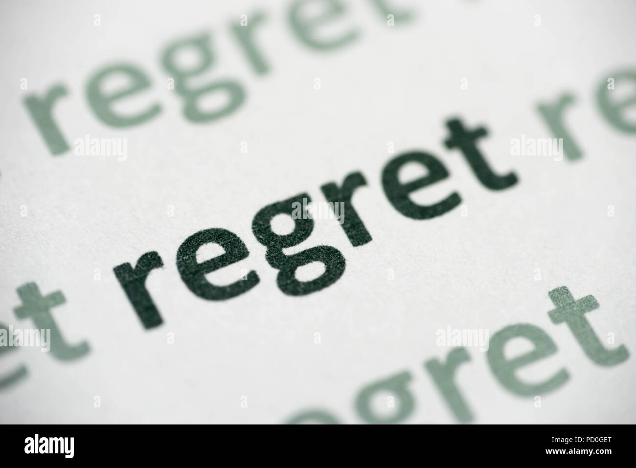 word regret printed on white paper macro Stock Photo - Alamy