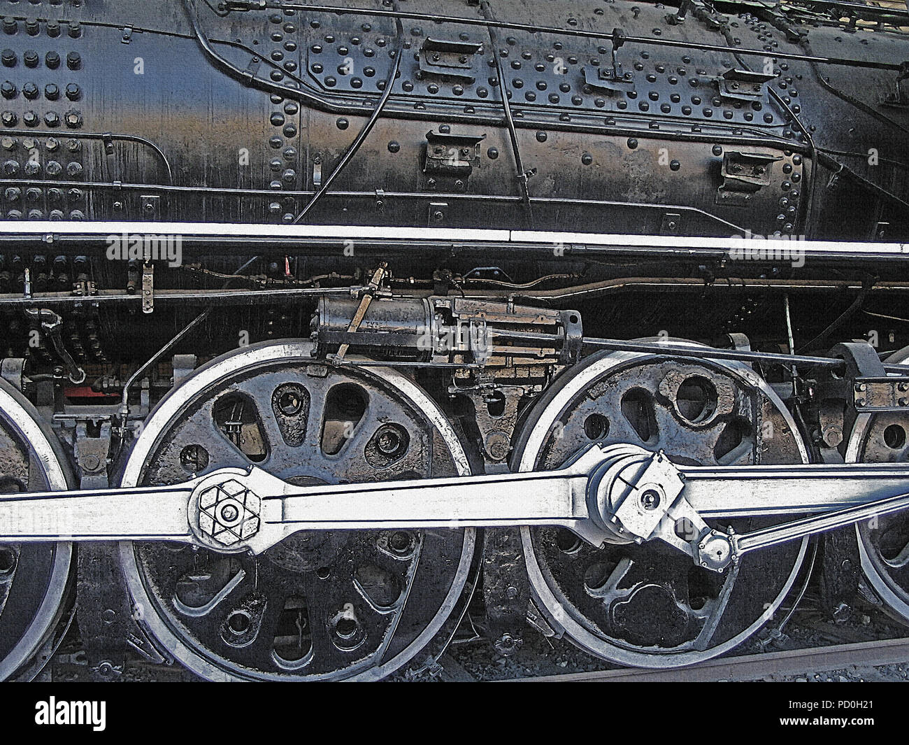 An up close, side view of an old painted black train steam engine ...