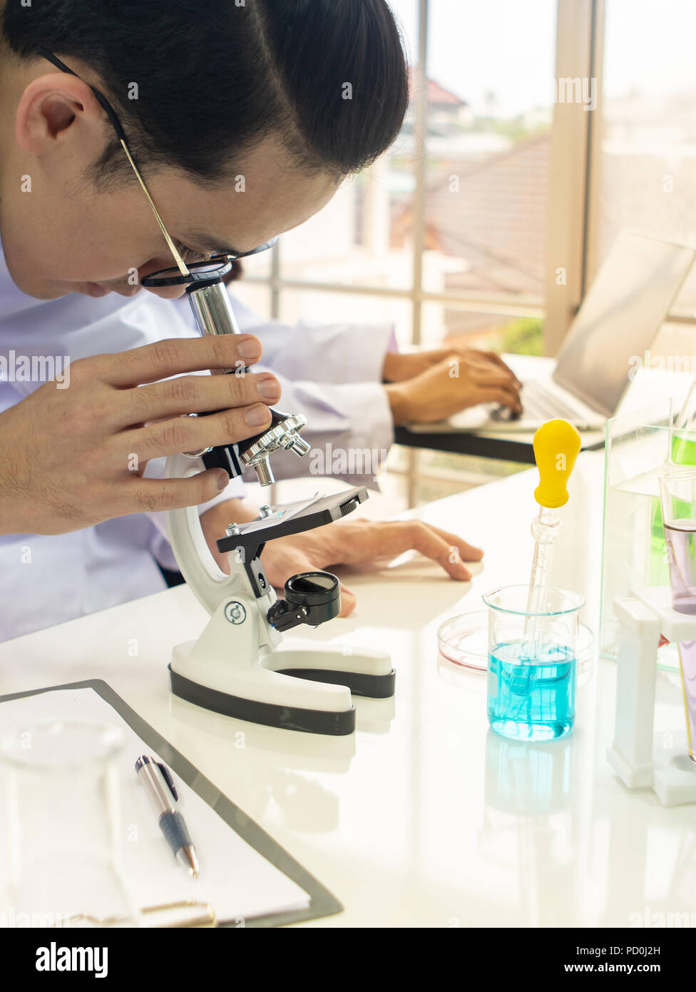 A female scientist analysing something hi-res stock photography and ...