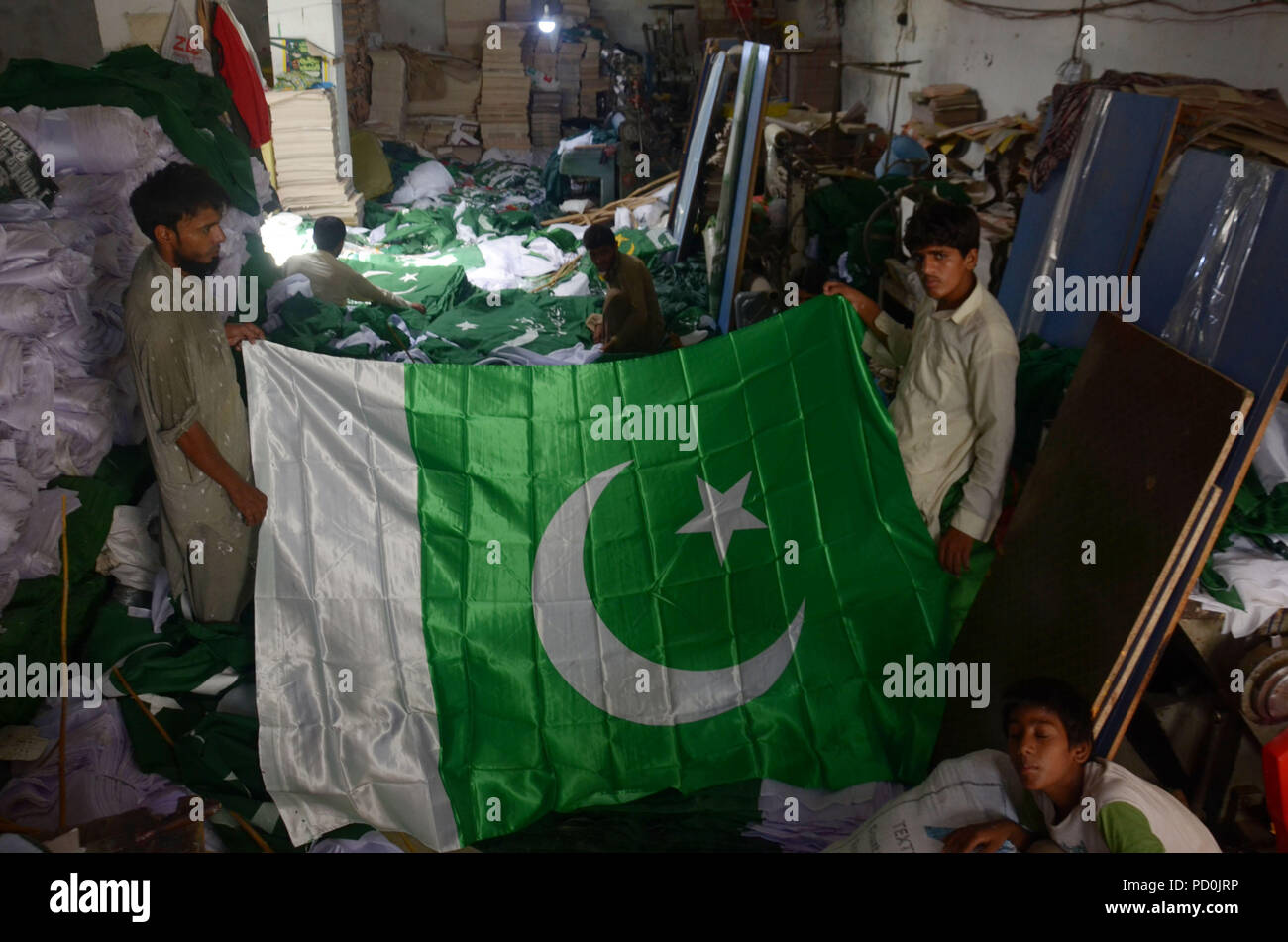 Lahore, Pakistan. 03rd Aug, 2018. Pakistani workers sorting national ...