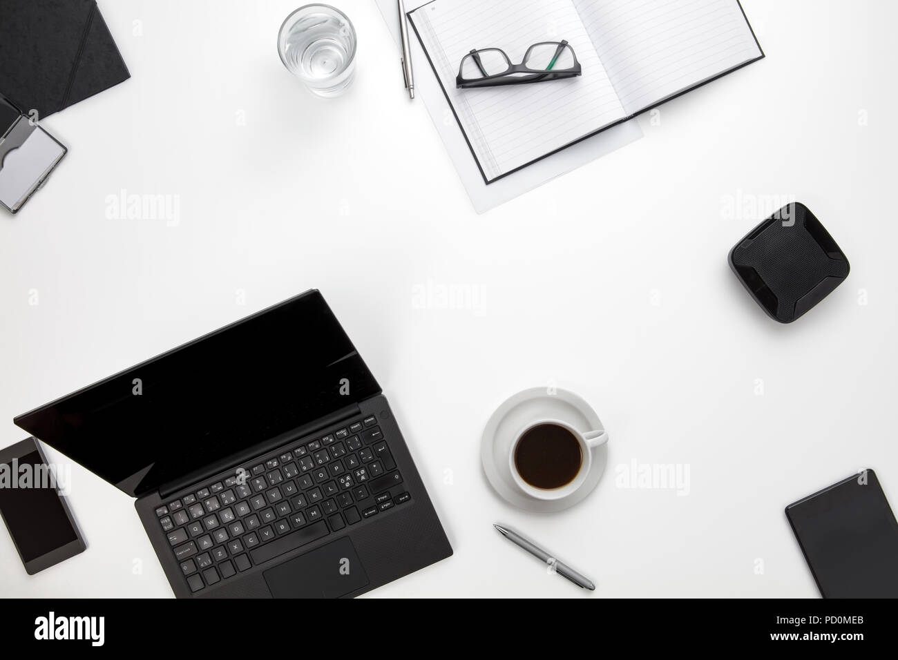 Devices And Office Supplies On White Desk Stock Photo - Alamy
