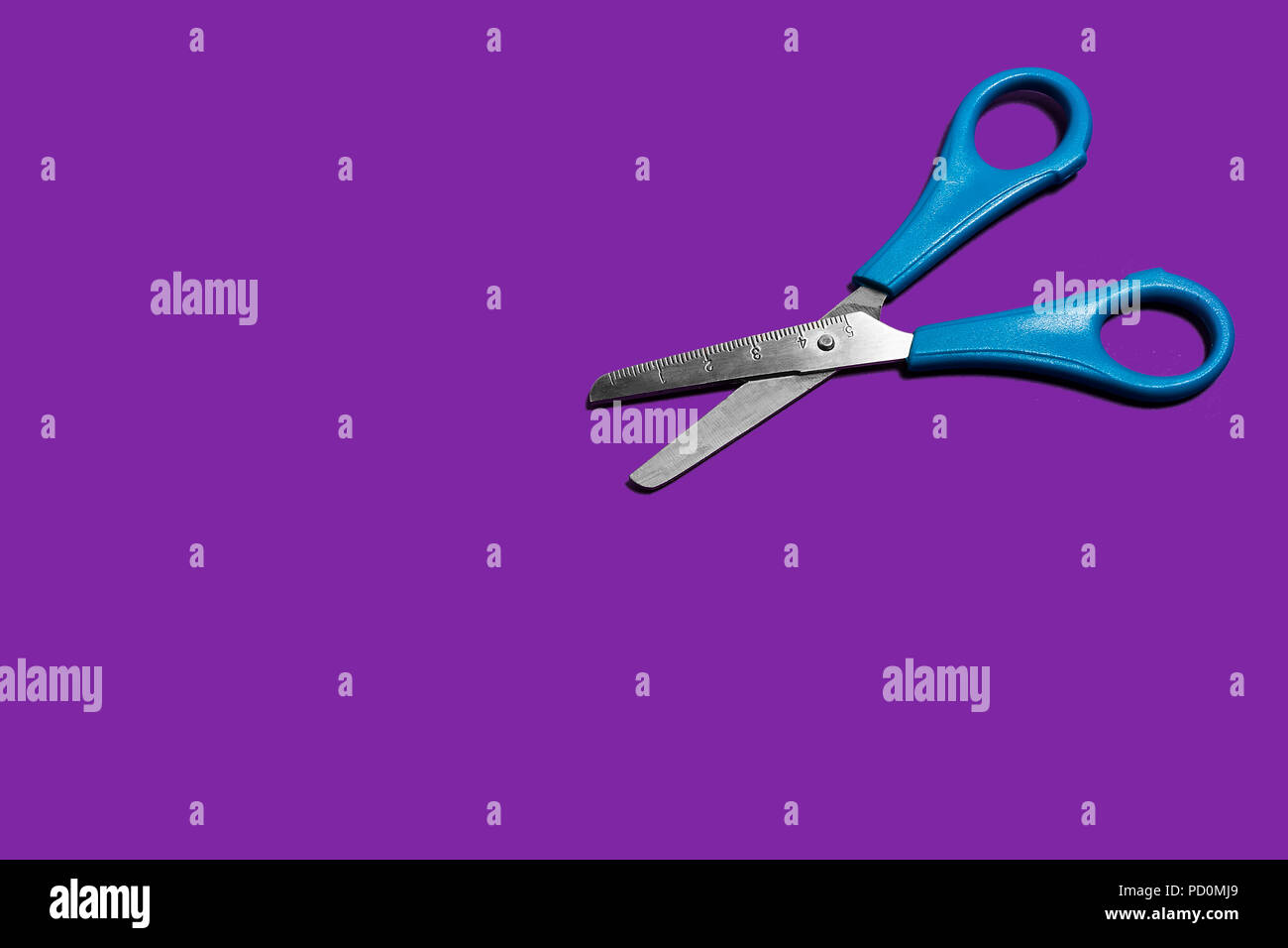 scissors on a purple background Stock Photo - Alamy