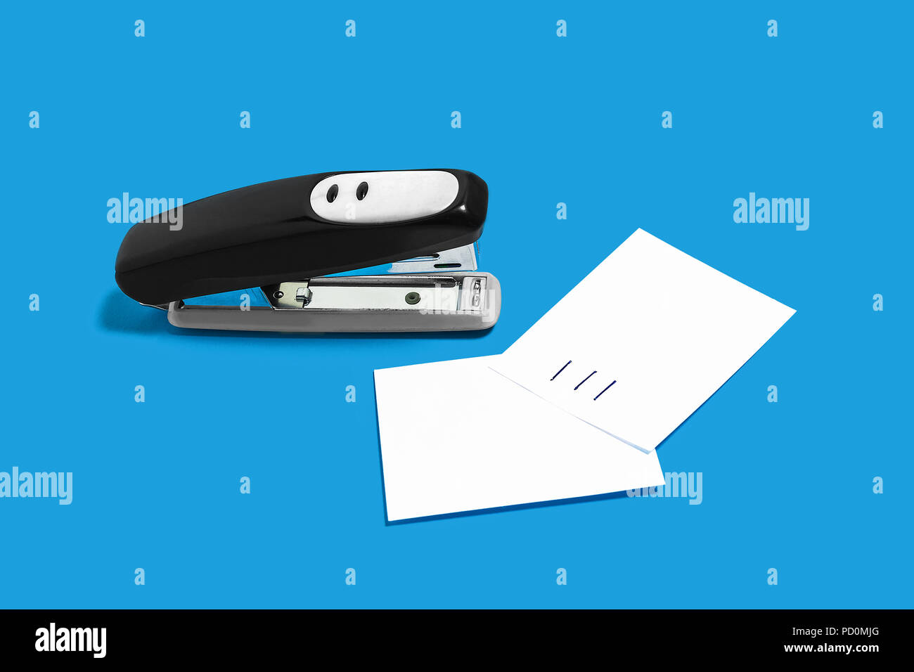 black stapler with sheets of paper Stock Photo - Alamy