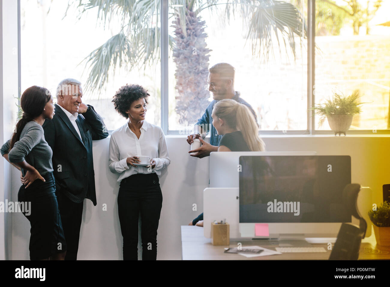 Group of business people having a casual discussion during coffee break ...