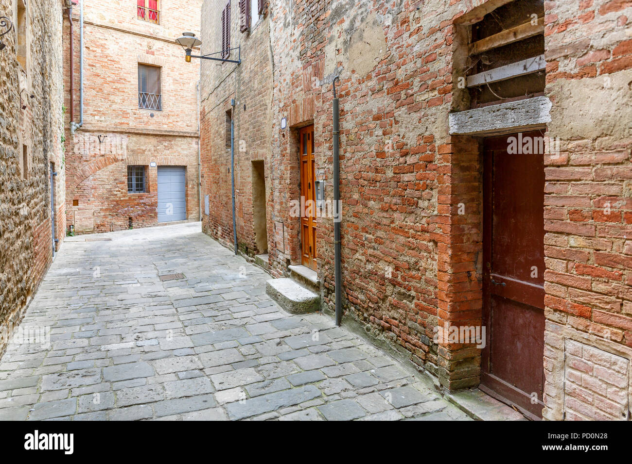 Doors in an old alley with paving stones Stock Photo - Alamy