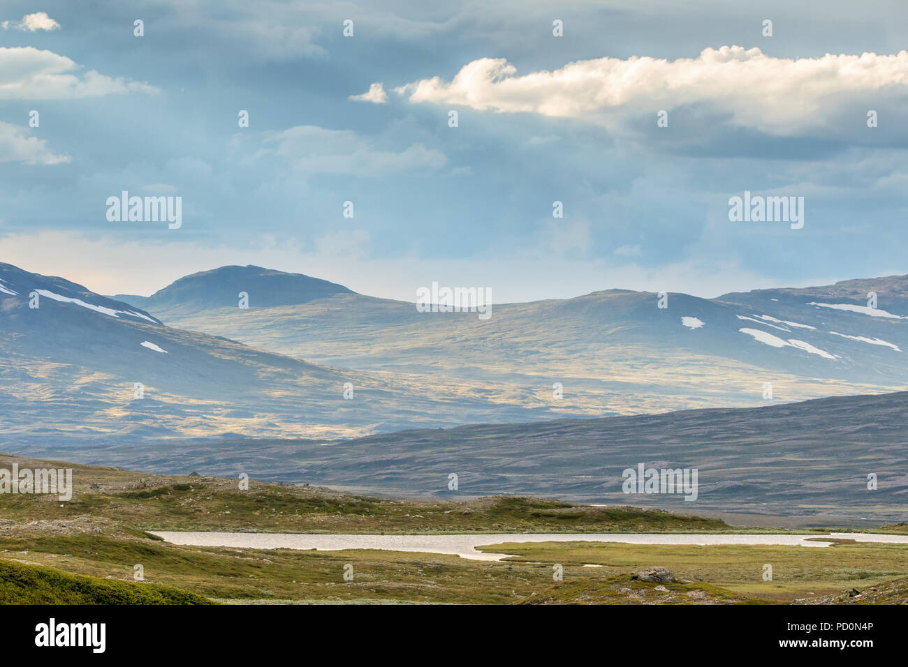 View of rolling mountain landscape with a lake Stock Photo - Alamy