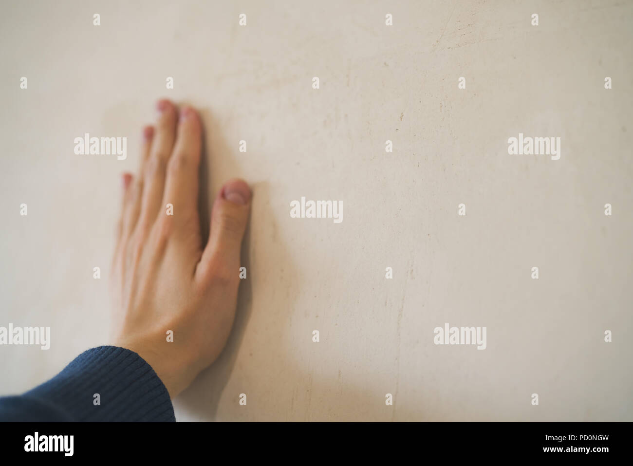 closeup young man hand touching plastered wall, construction works ...