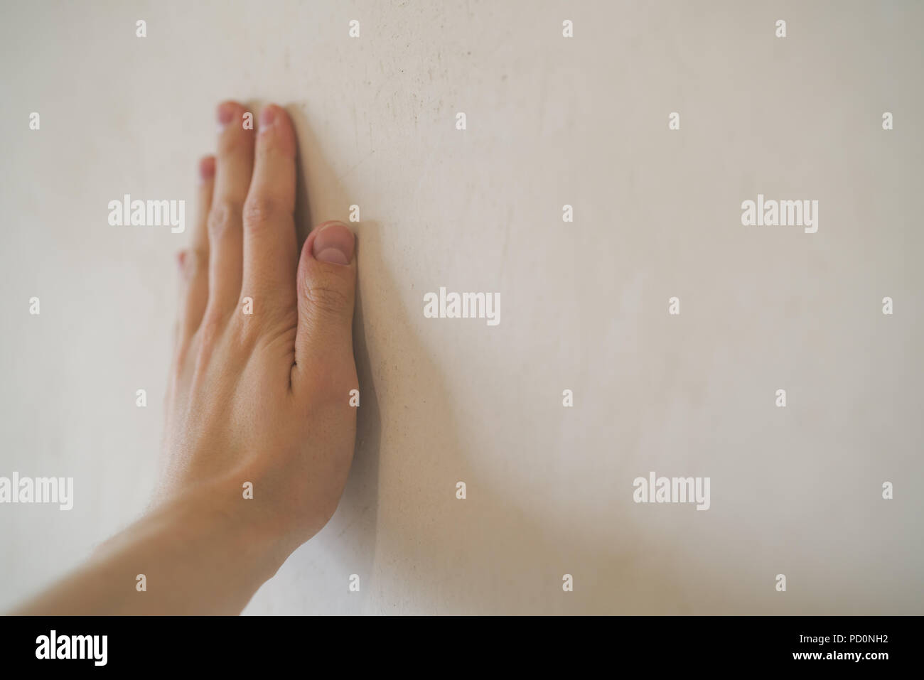 closeup young man hand touching plastered wall, construction works ...