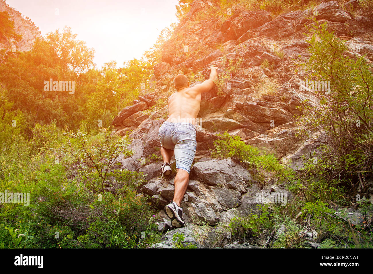 Rock climber. Strong young man climbing on a limestone wall with ...