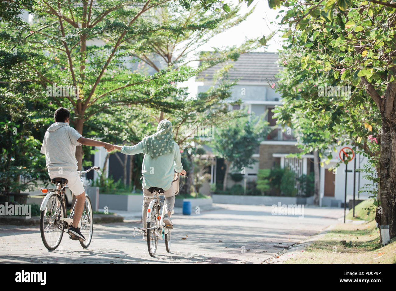 muslim couple riding a bike Stock Photo - Alamy