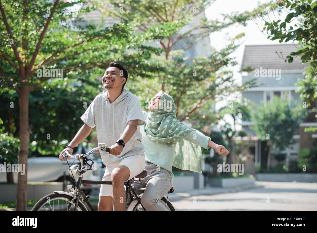 woman and man riding a bike Stock Photo - Alamy