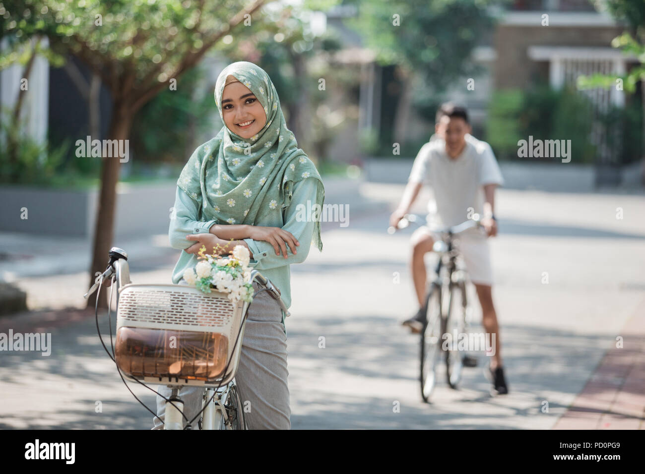 muslim woman riding a bicycle Stock Photo - Alamy