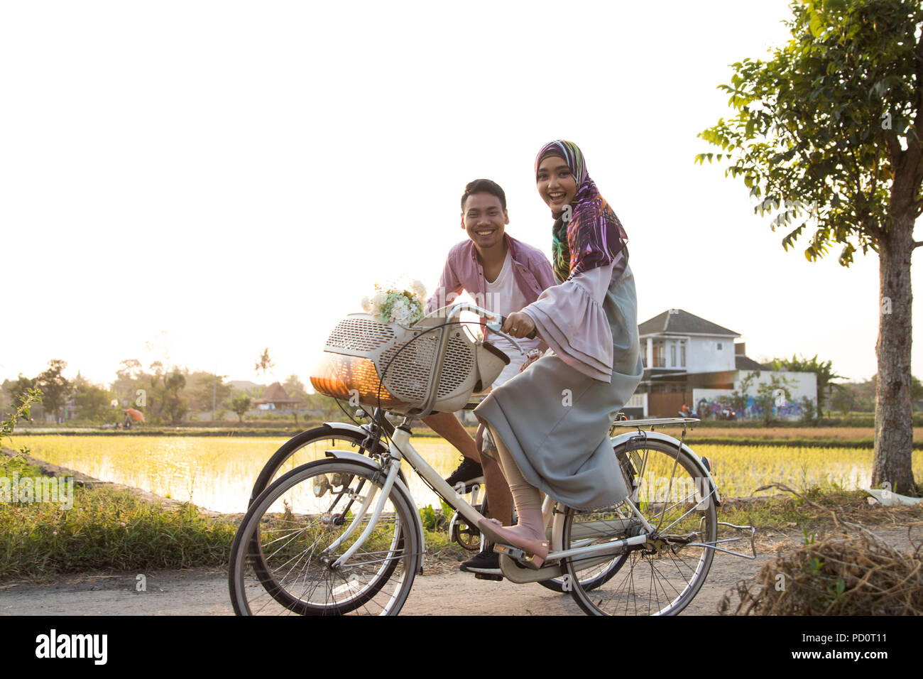 muslim couple riding a bike Stock Photo - Alamy