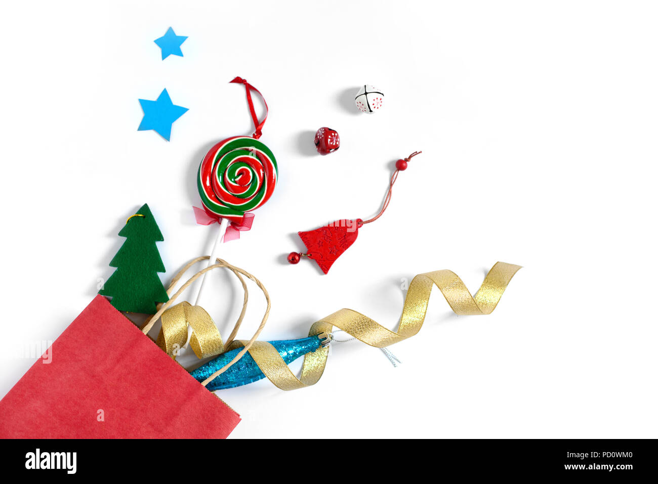 Christmas gifts falling from the red shopping bag, holiday presents ...