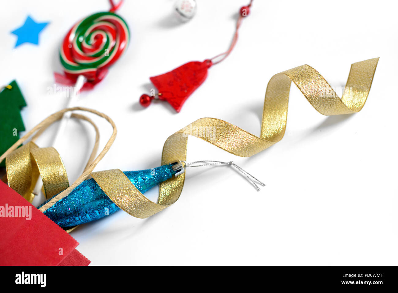 Christmas gifts falling from the red shopping bag, holiday presents ...