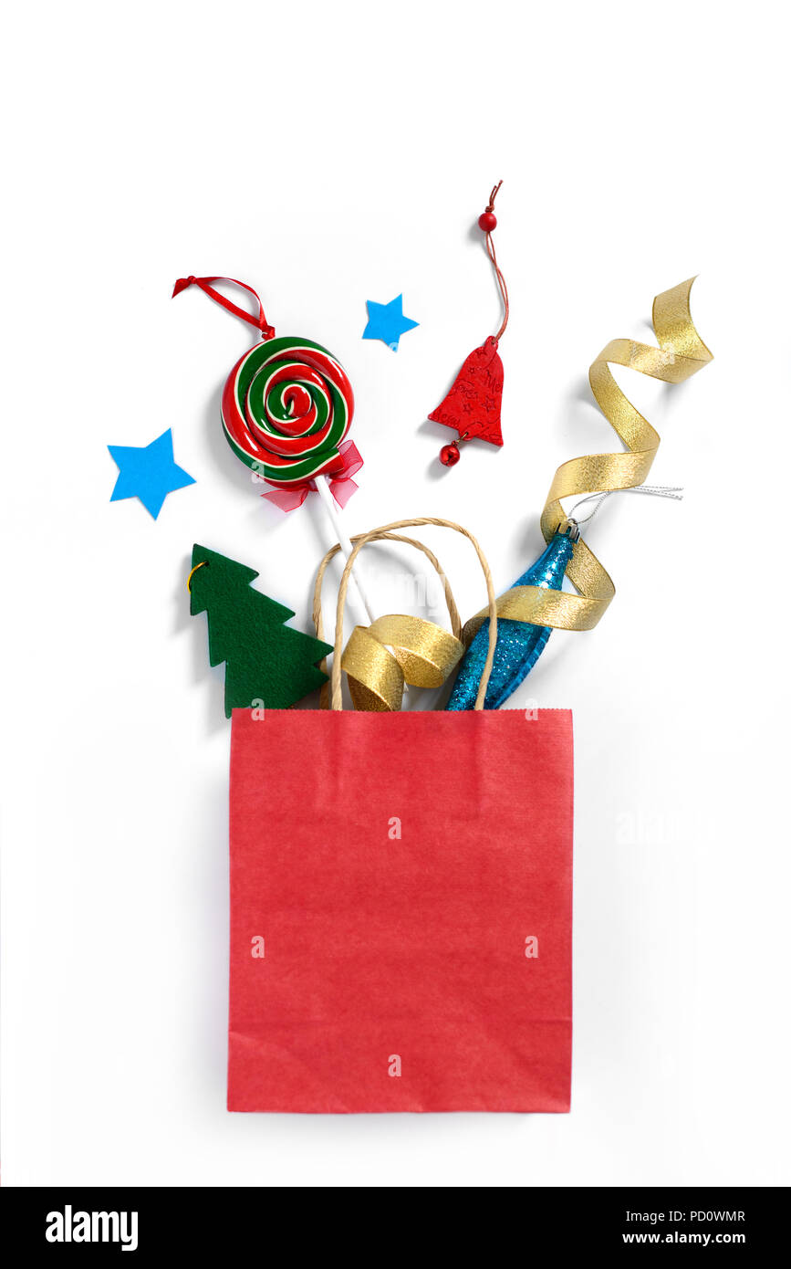 Christmas gifts falling from the red shopping bag, holiday presents ...