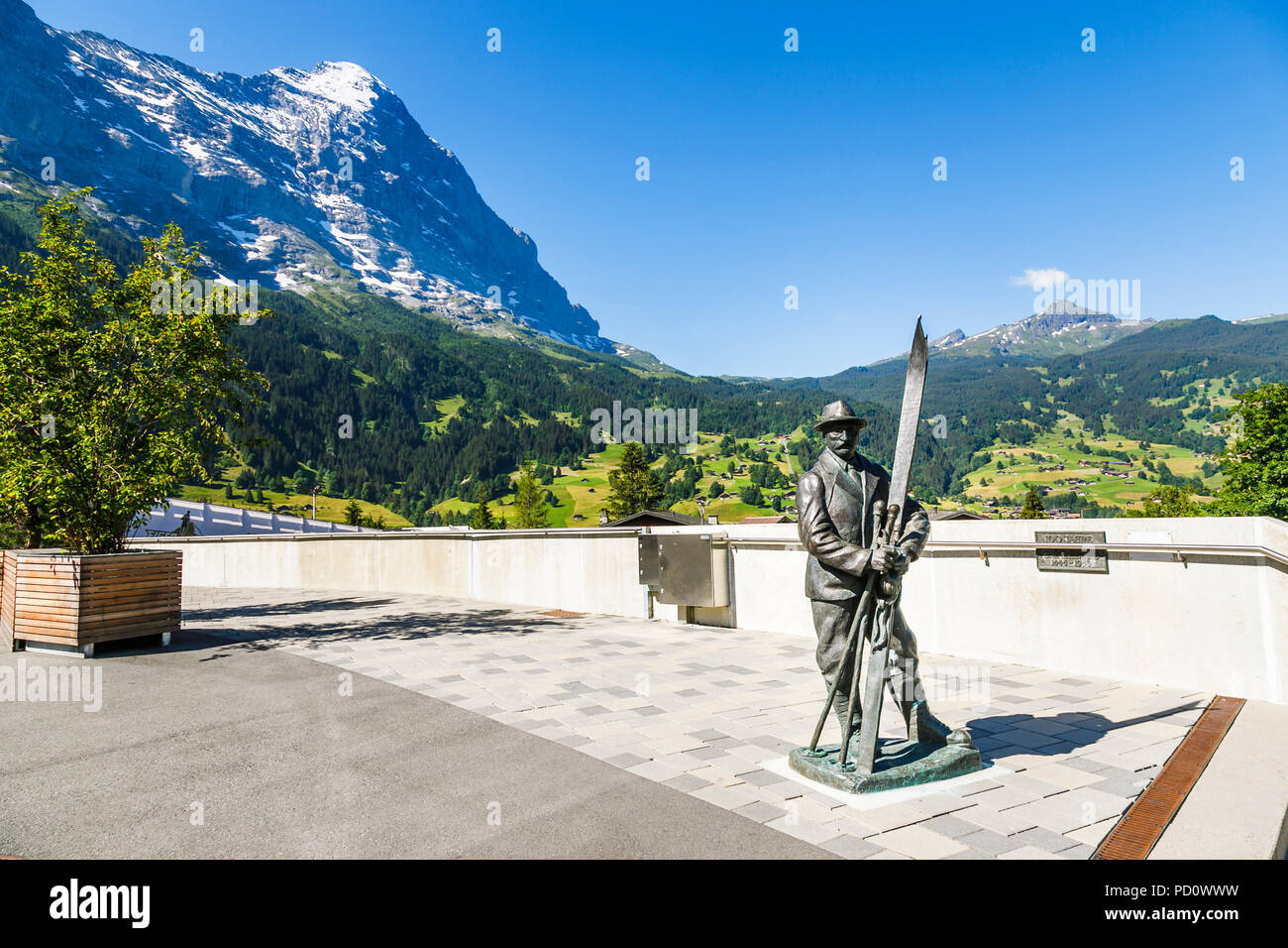 Statue of an early skier in Grindelwald village centre, the Eiger ...