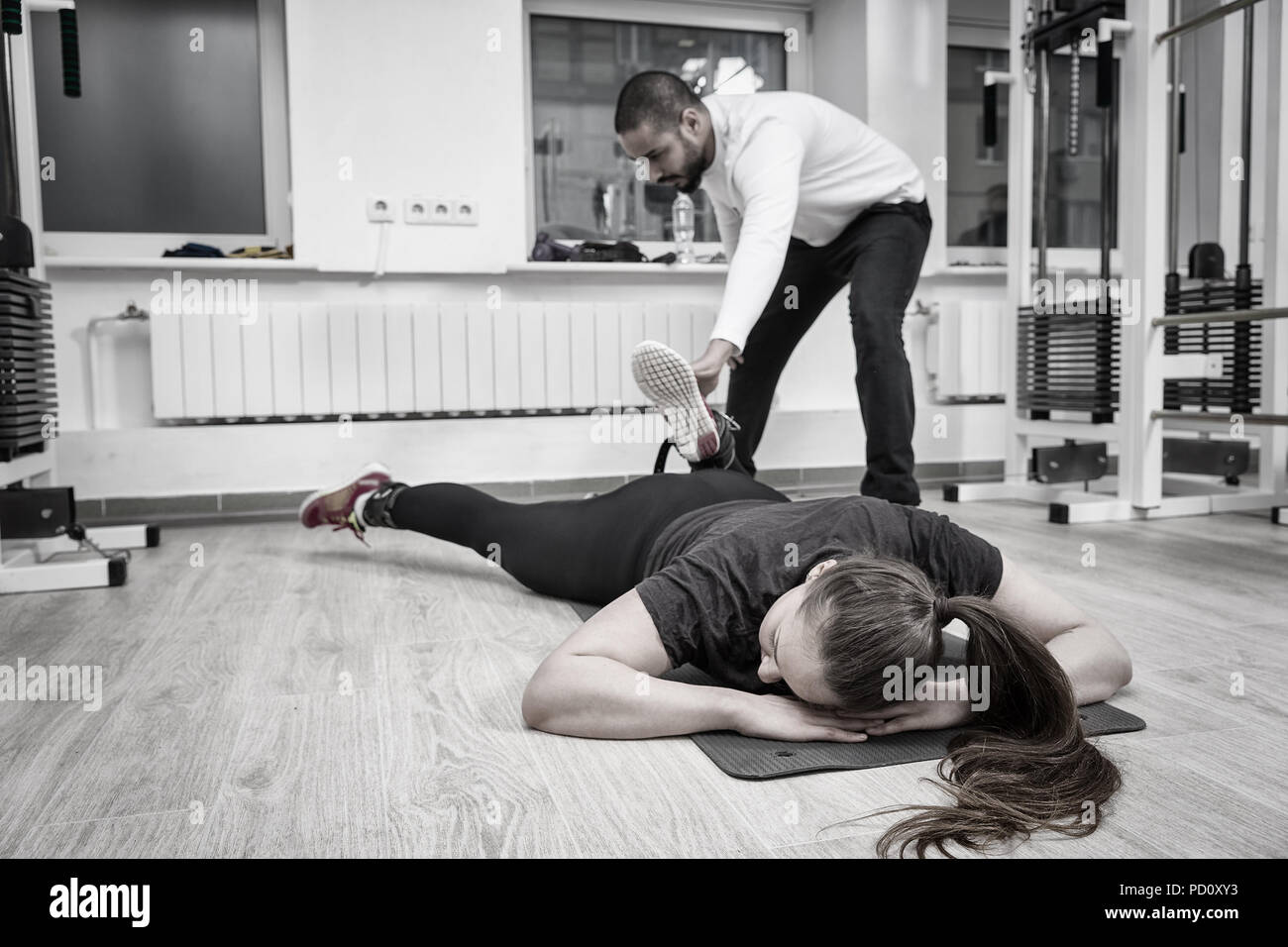 Personal trainer holding leg hi-res stock photography and images - Alamy