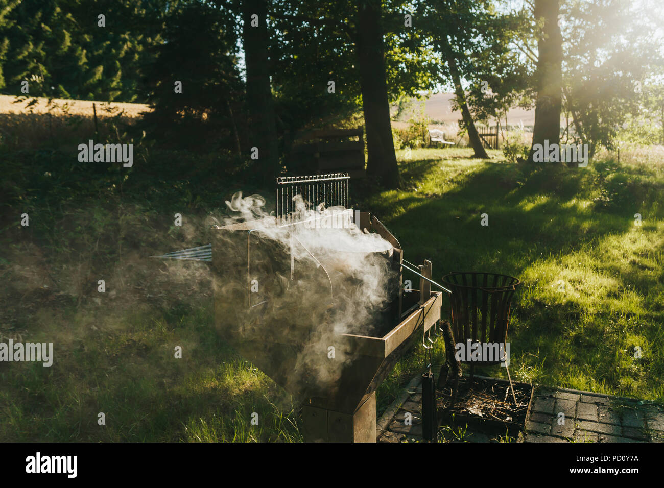 photo of smoke appearing on a grill while lighting a barbecue Stock ...