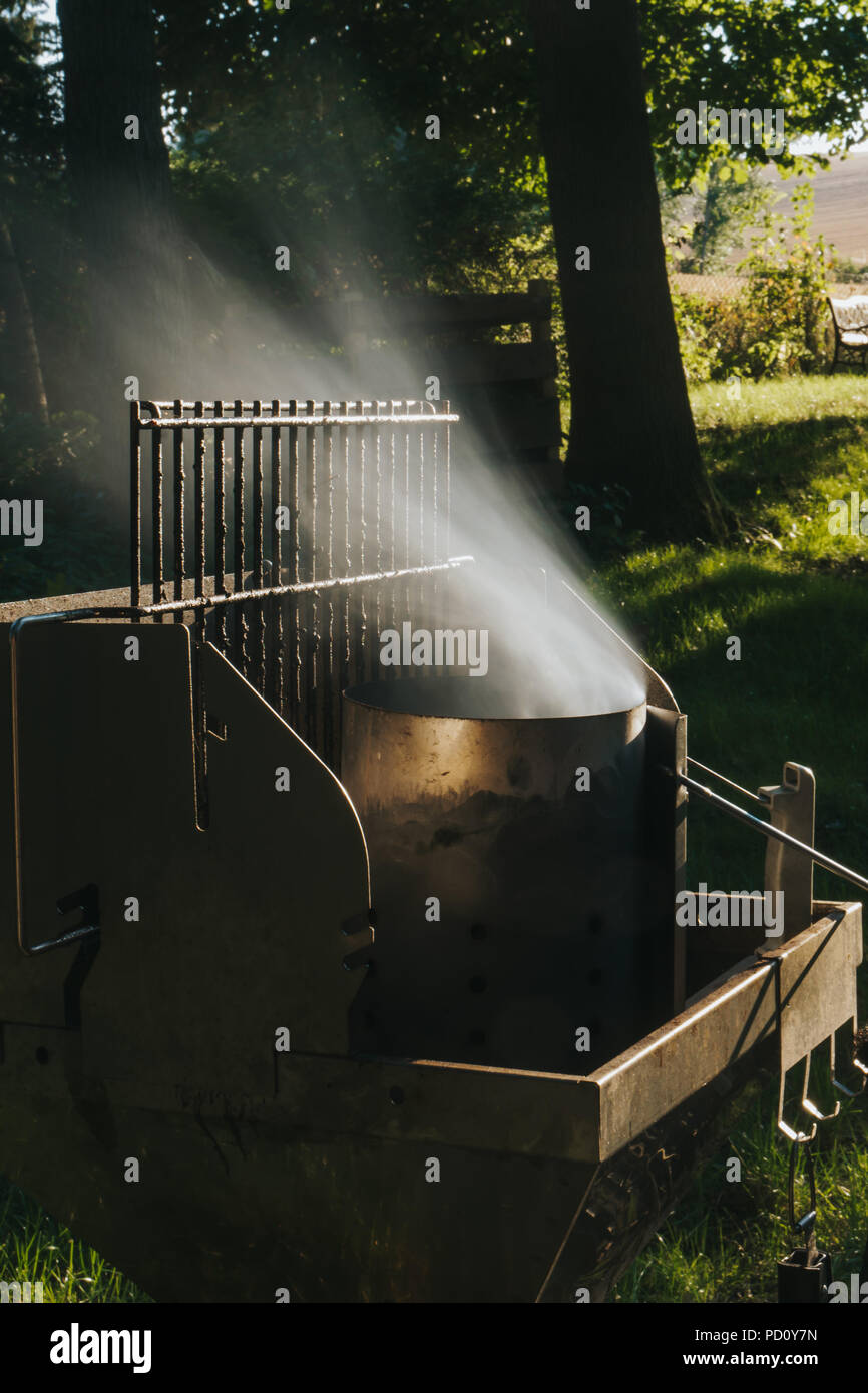 photo of smoke appearing on a grill while lighting a barbecue Stock ...