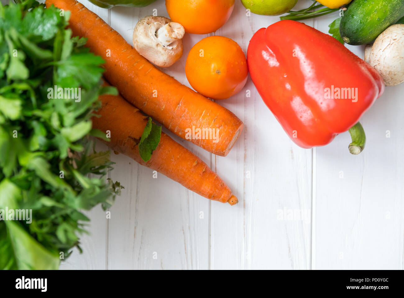 Fresh vegetable corner border with copy space on white wood with a red ...