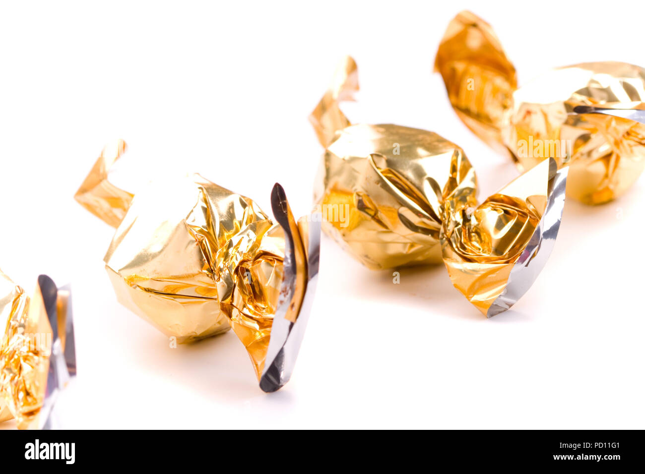 golden sweets closeup on white background Stock Photo - Alamy