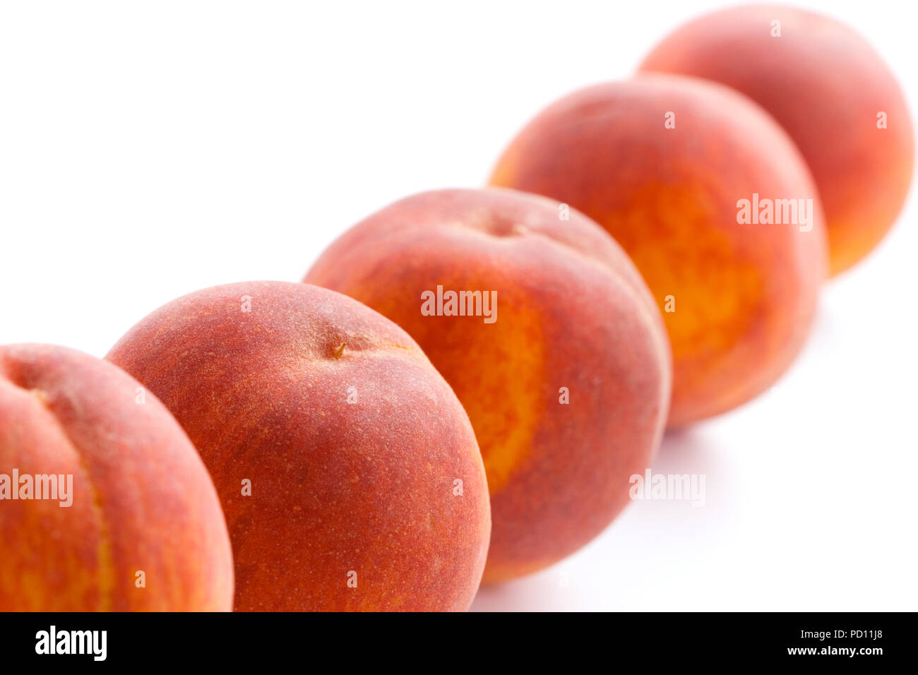 five peaches on white background Stock Photo - Alamy