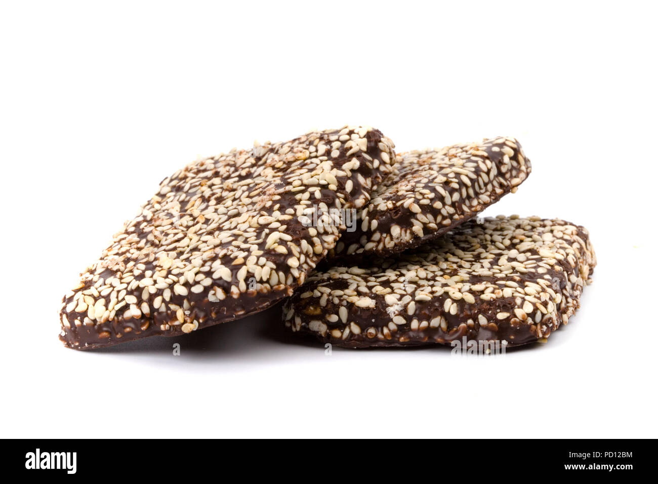 three chocolate coocies with sesame seeds isolated on white background ...