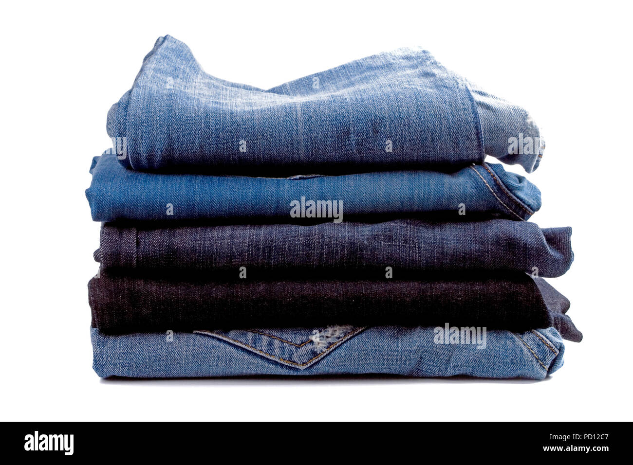 stack of blue jeans isolated on white background Stock Photo - Alamy