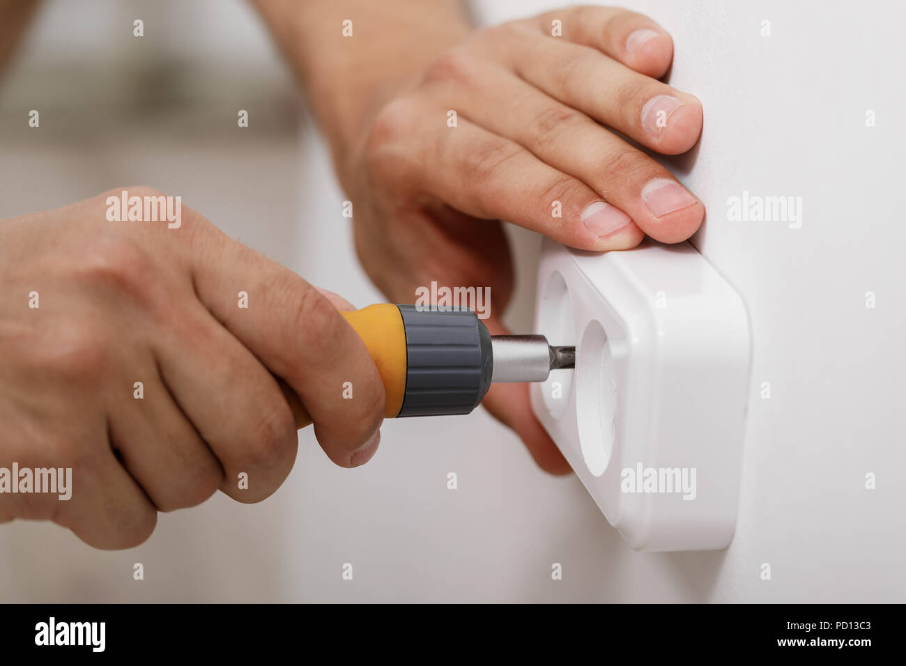 electrician installing electrical socket Stock Photo - Alamy