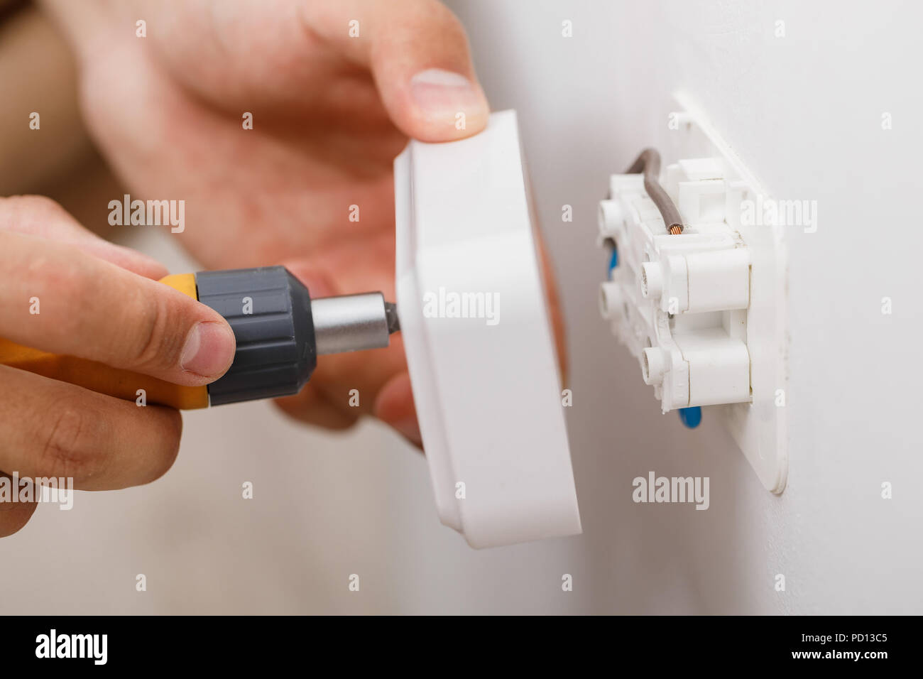 electrician installing electrical socket Stock Photo - Alamy