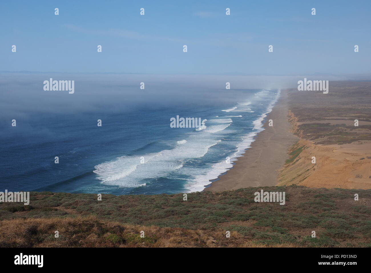 Looking down at the waves breaking onto the beach at Point Reyes ...