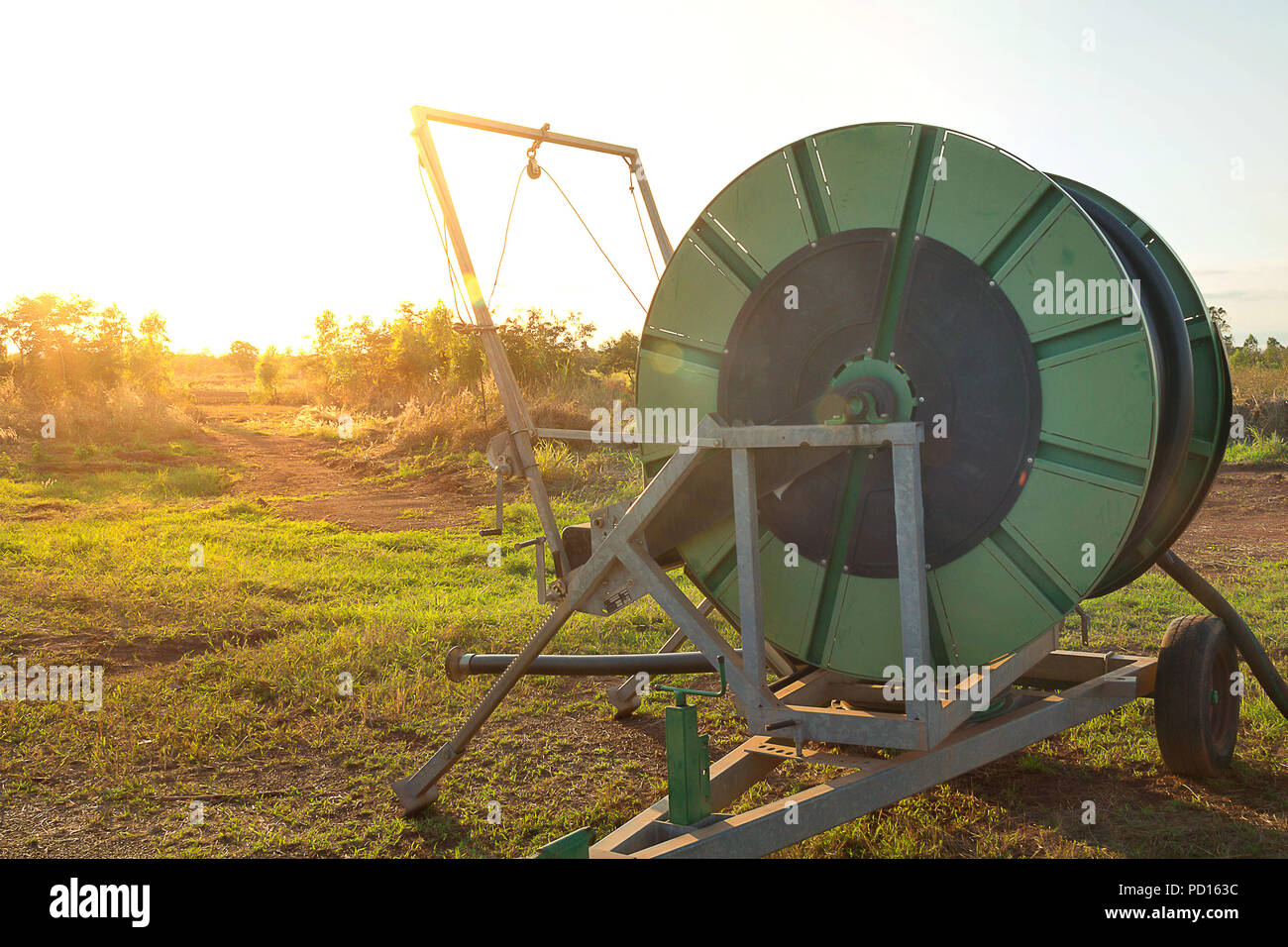Agricultural water pipeline at farm with sunset Stock Photo - Alamy
