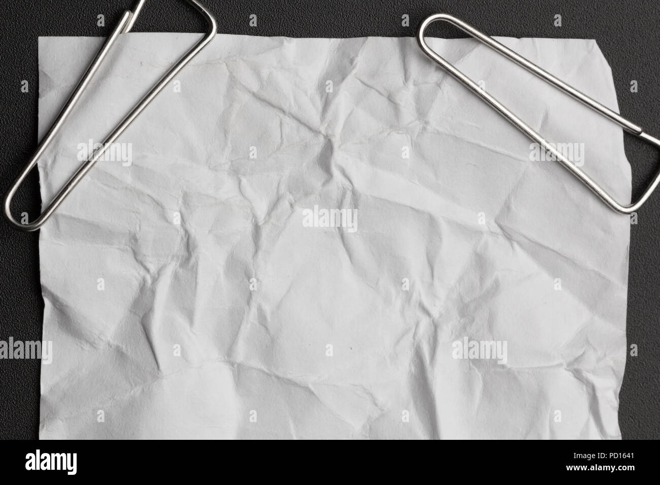 close up of a stack of papers and paper clip on black background Stock ...