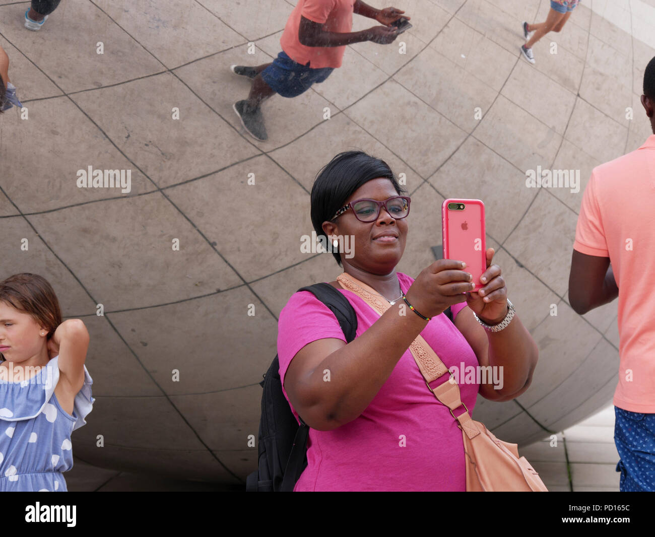 Young woman taking a selfie at Cloud Gate in Chicago's Millennium Park ...