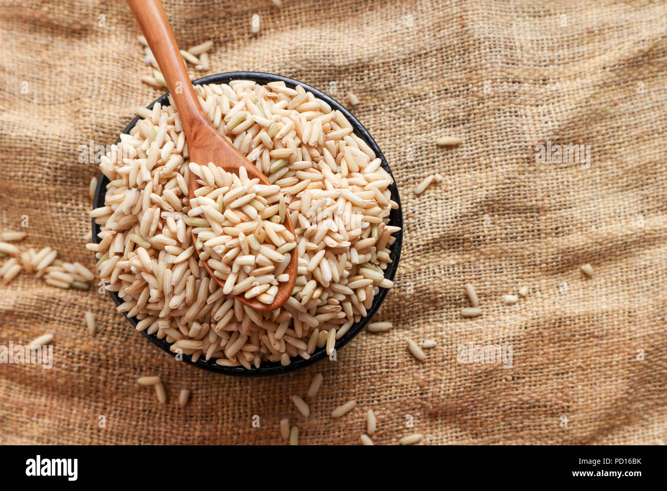 Raw brown rice in a spoon and bowl. top view food background Stock ...