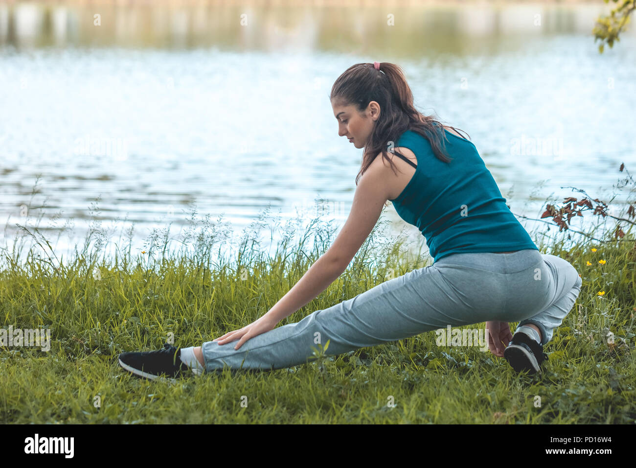 Beautefull girl with fitness exercise for relax and healthy at lake ...