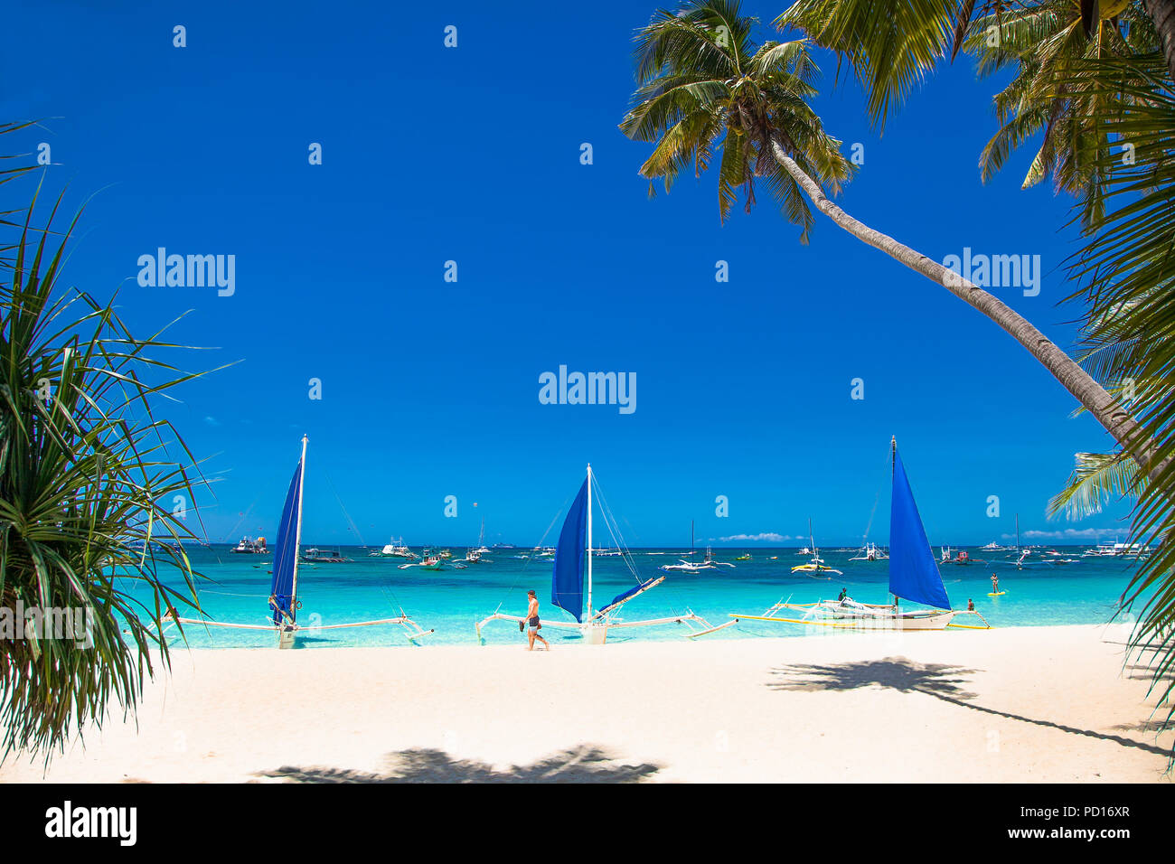 Philippine traditional boat with blue sail on White Beach. Boracay ...