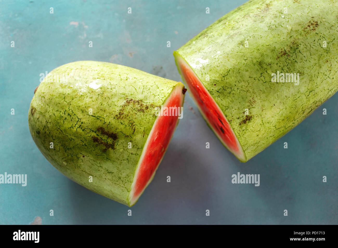 Half watermelon on stone blue background top view Stock Photo - Alamy