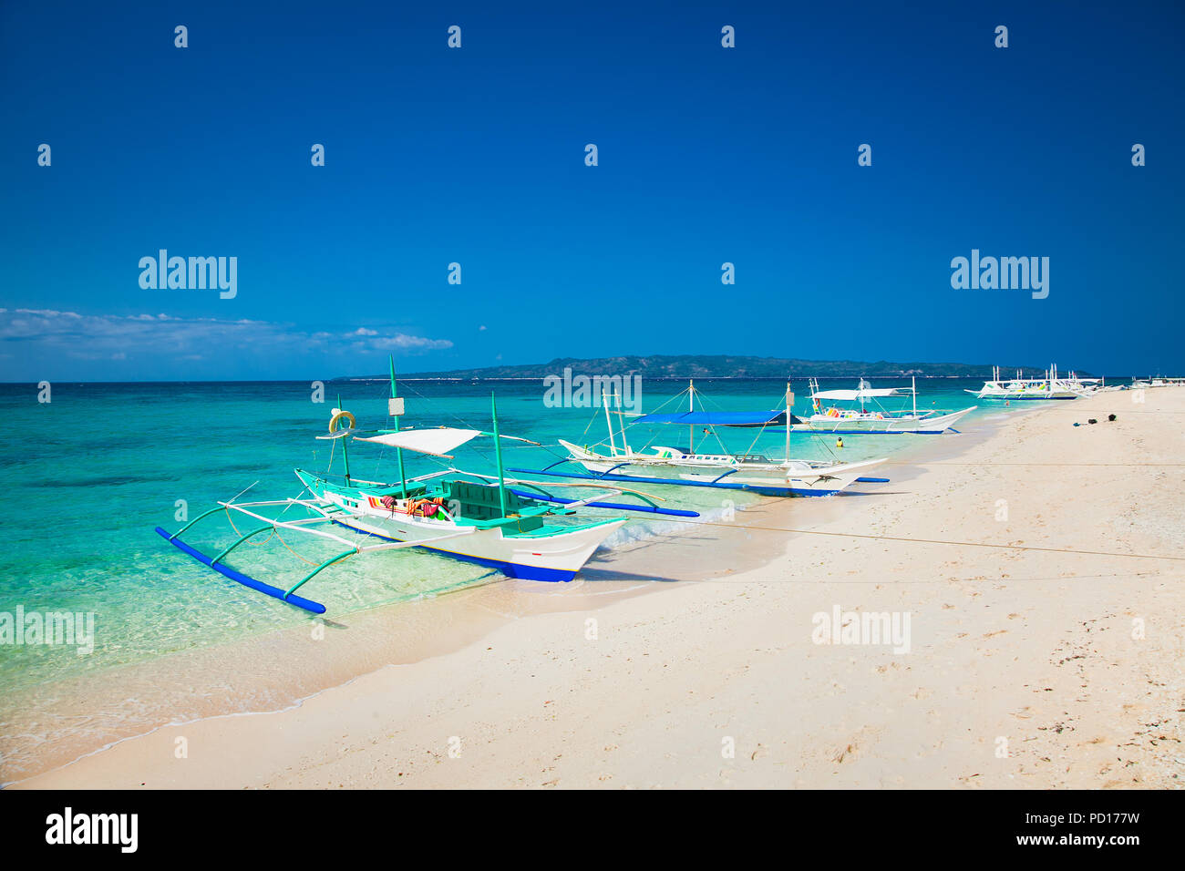 Traditional boat that do a island hopping in the beautiful Puka Beach ...