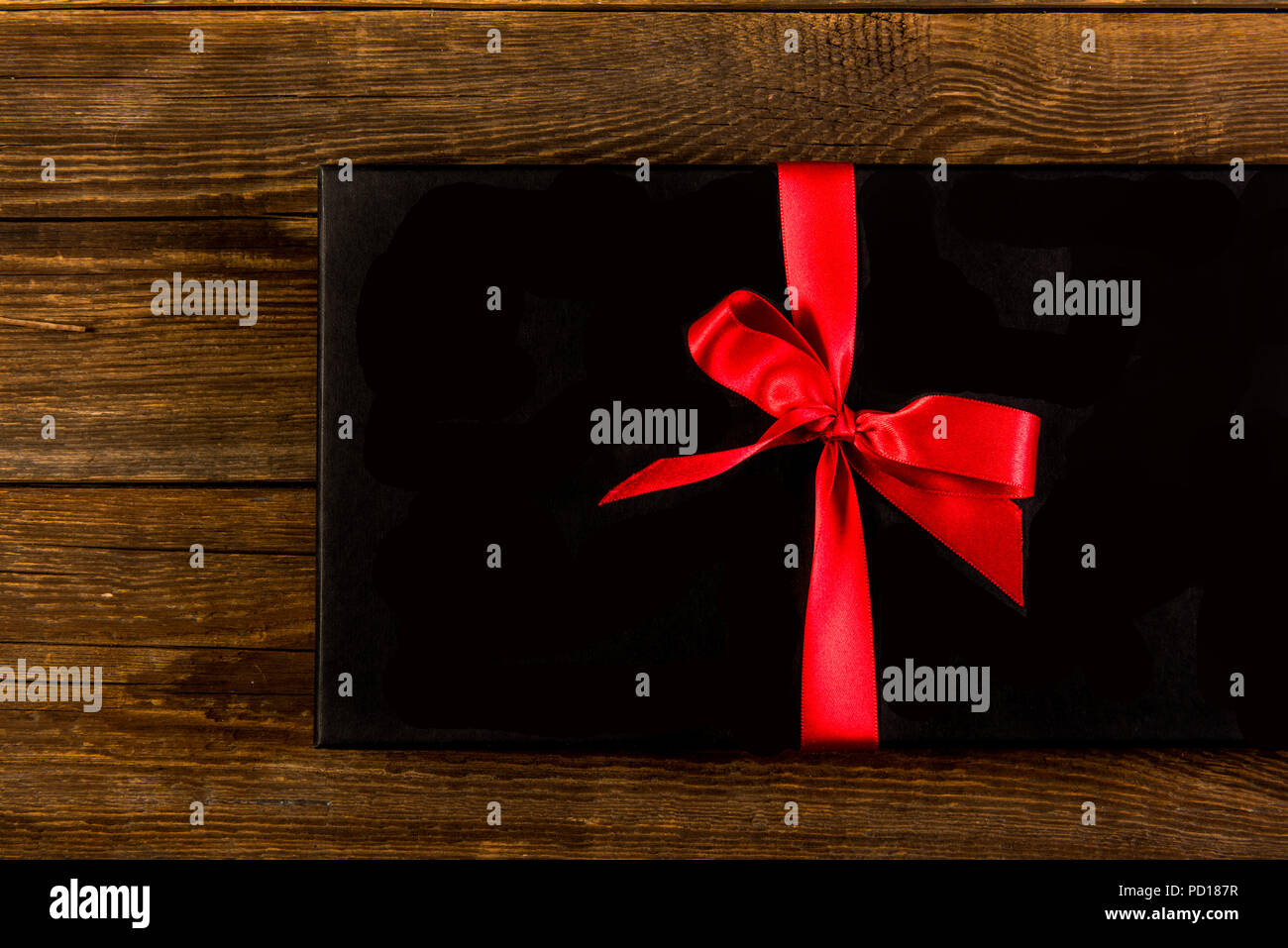 red ribbon on a black background Stock Photo - Alamy