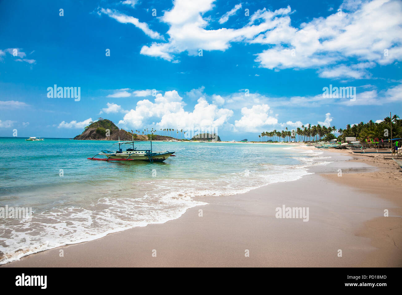 Traditional boat on shore at tropical Nacpan beach at Palawan island ...