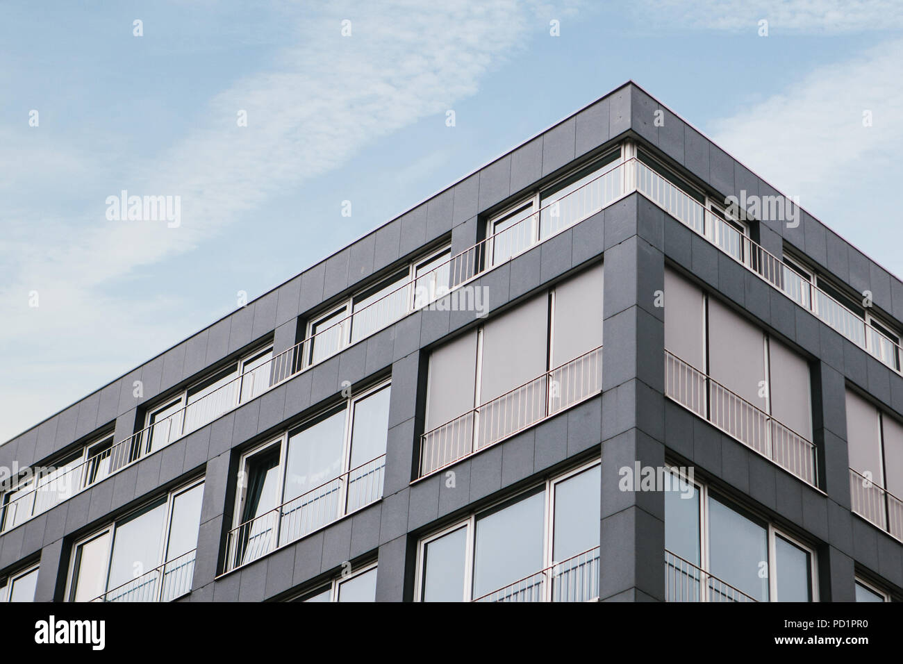 The corner of the building with many windows in a minimalistic style ...