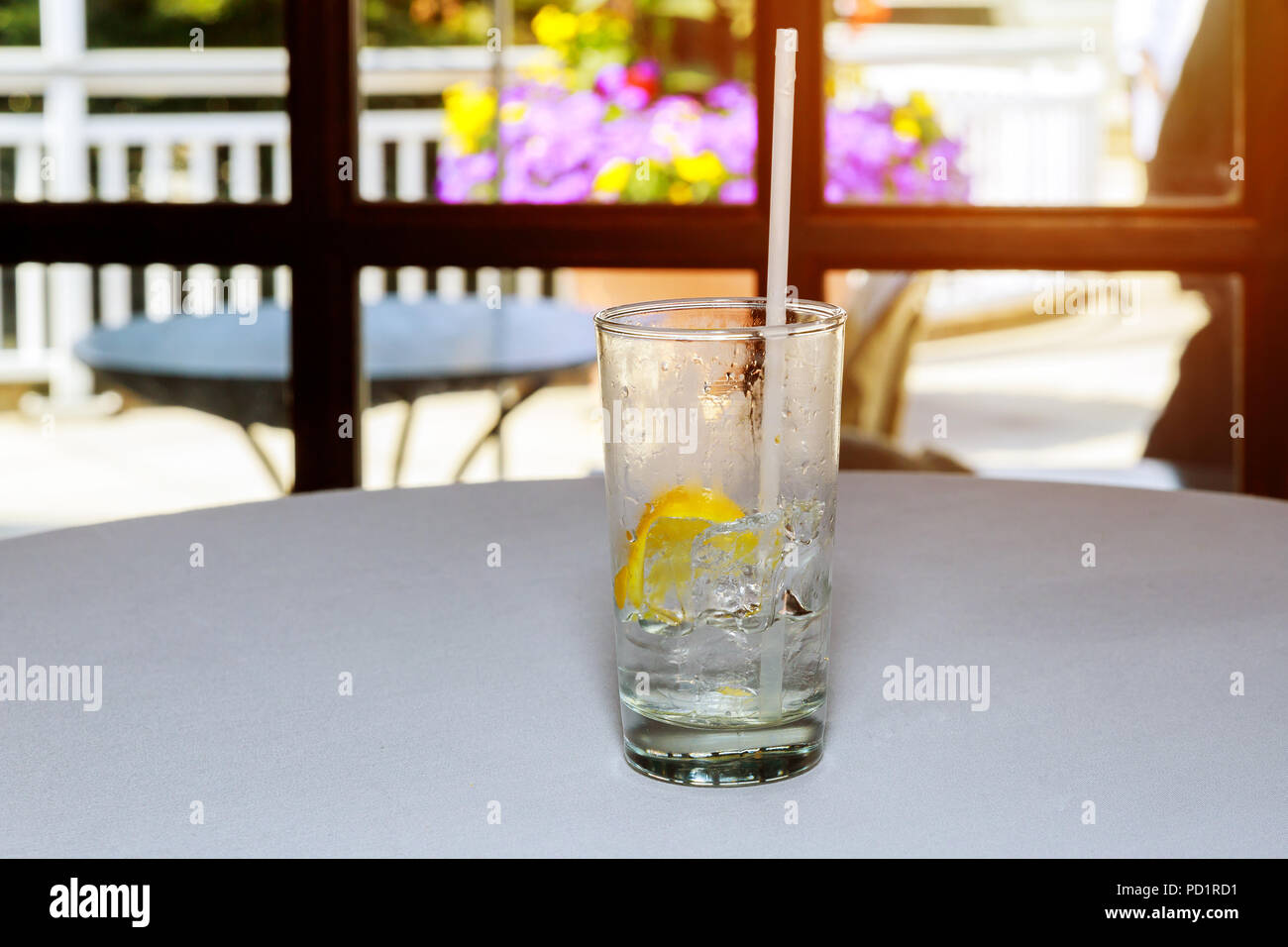 Summer fresh drink cold lemonade empty glass of ice and a slice of ...