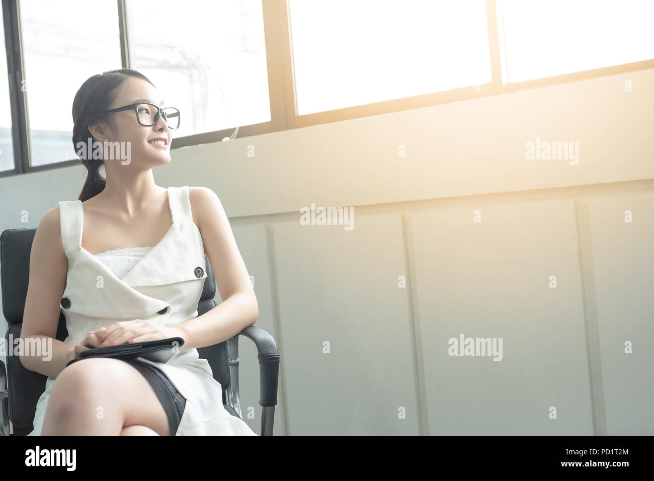 Young business woman in white dress who is candidate sitting wait for ...