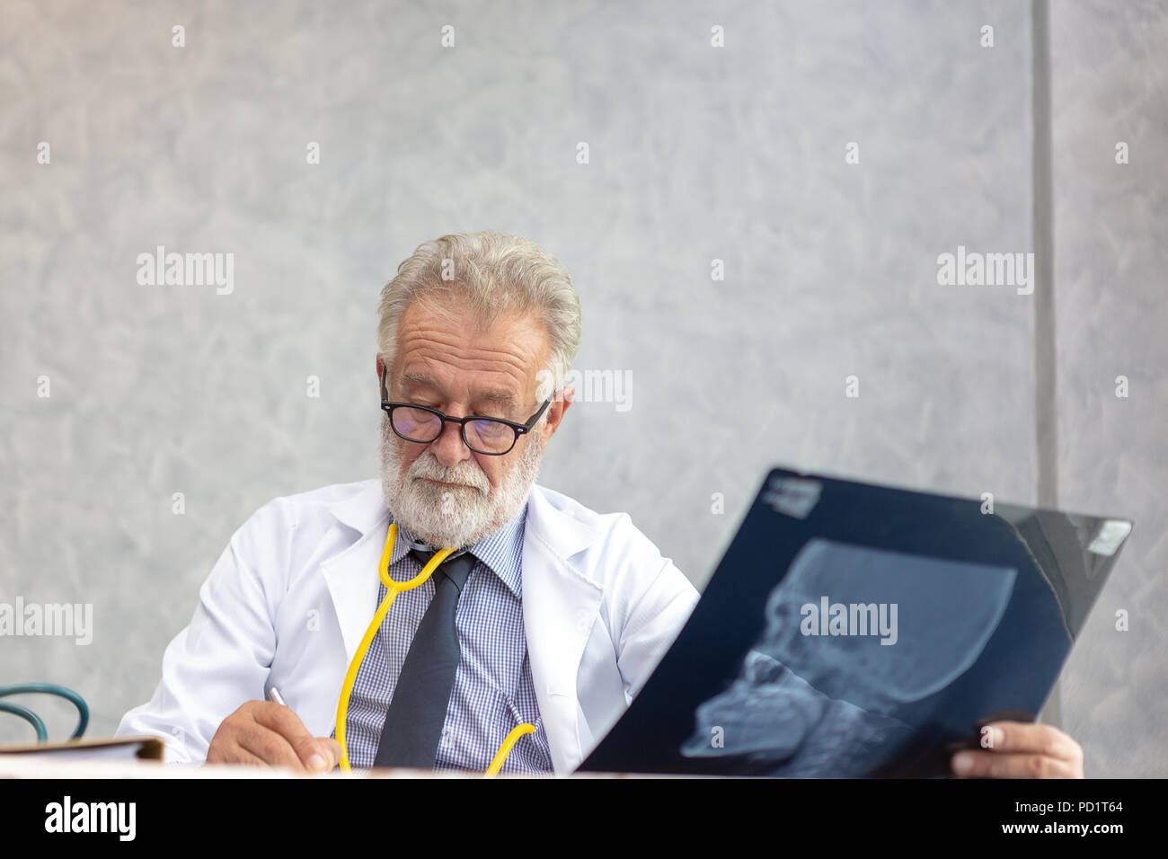 Senior medical doctor or chief doctor or Surgeon are checking skull of ...