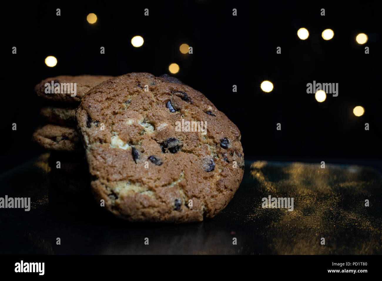 Cookies on dark background with fairy lights Stock Photo - Alamy